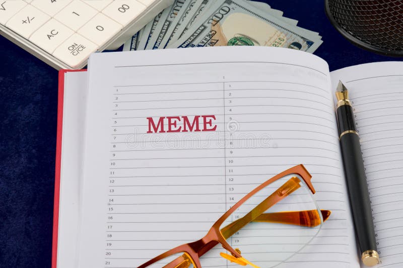 Notebook Open To the Word Meme with Glasses and Money Present on a Desk ...