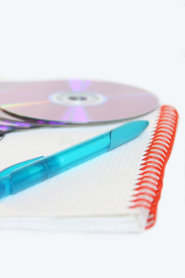 Notebook with pen and CDs stock image. Image of book - 12867781