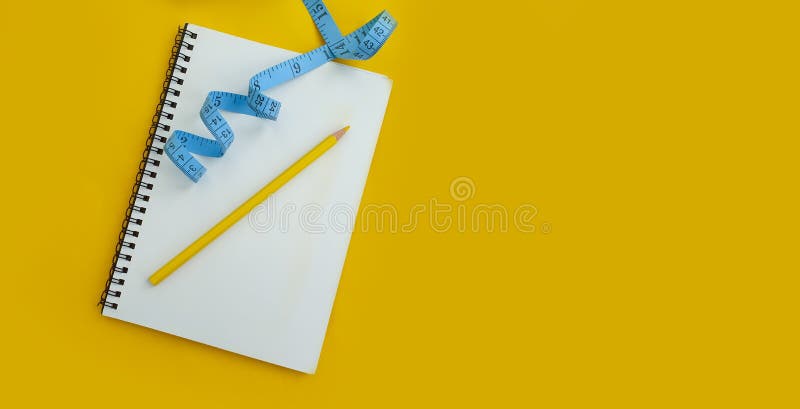 Notebook, Pen, Measuring Tape on a Colored Background Stock Photo ...