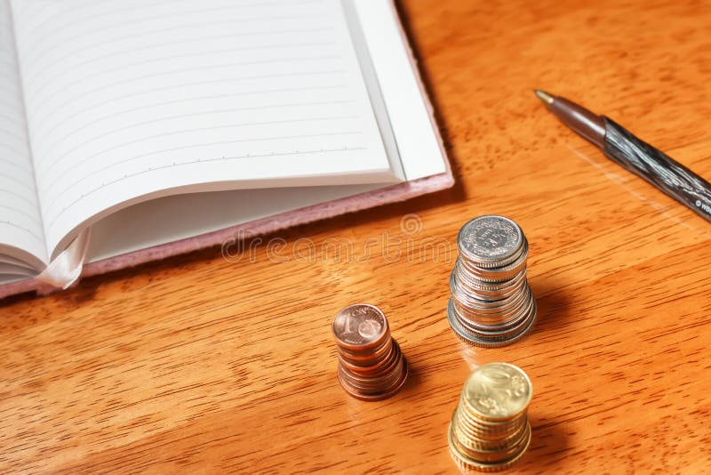 Notebook with Pencil and Stacks of Coins Stock Image - Image of leaf ...