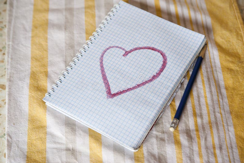 A Notebook with Pictured Heart on a Table Stock Image - Image of towel ...