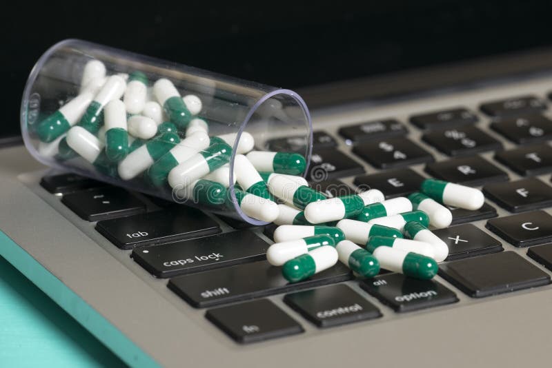 Notebook and pills stock image. Image of laptop, design - 144625687