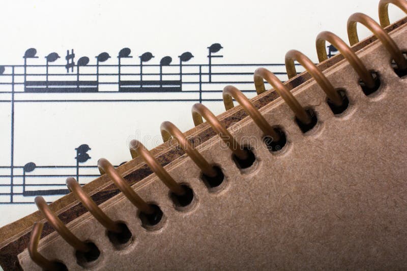 Notebook Placed on Paper with Musical Notes Stock Image - Image of ...