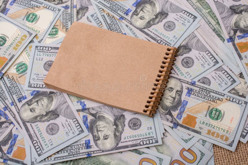 Notebook Placed is Placed on US Dollar Banknotes Stock Photo - Image of ...