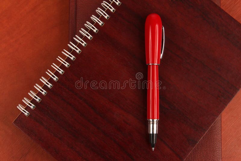 Notebook and a Red Pen Lying on Wooden Desk Stock Image - Image of book ...