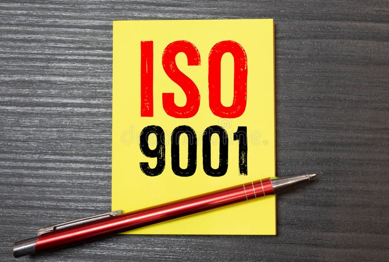 Notebook with Text Inside ISO 9001 on Table with Coffee, Mobile Phone ...