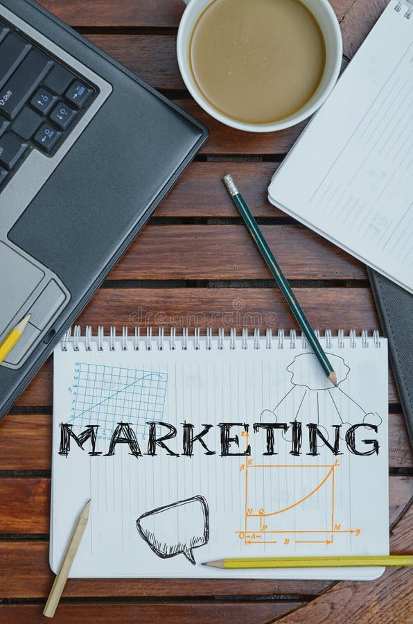 Notebook with Text Inside Marketing on Table with Coffee, Notebook and ...