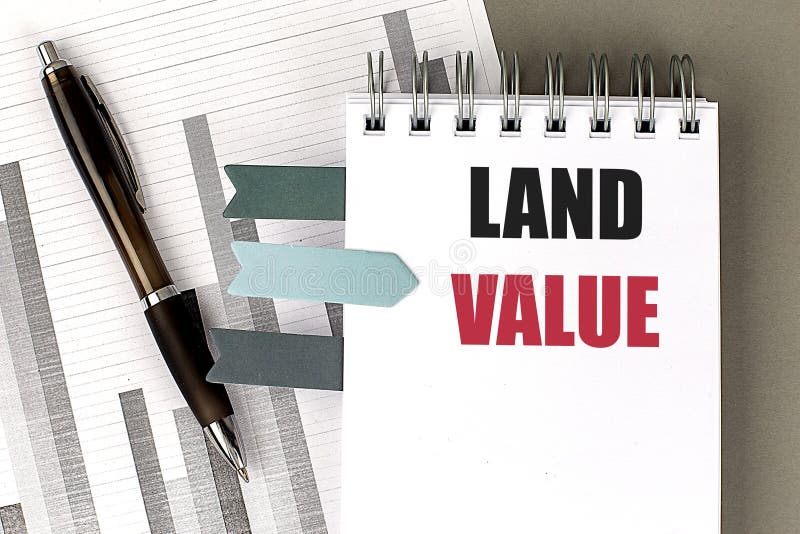 Notebook with the Text Land Value on a Desk with Charts, a Pen, and ...