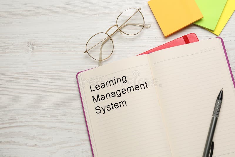 Notebook with Text Learning Management System on White Wooden Table ...