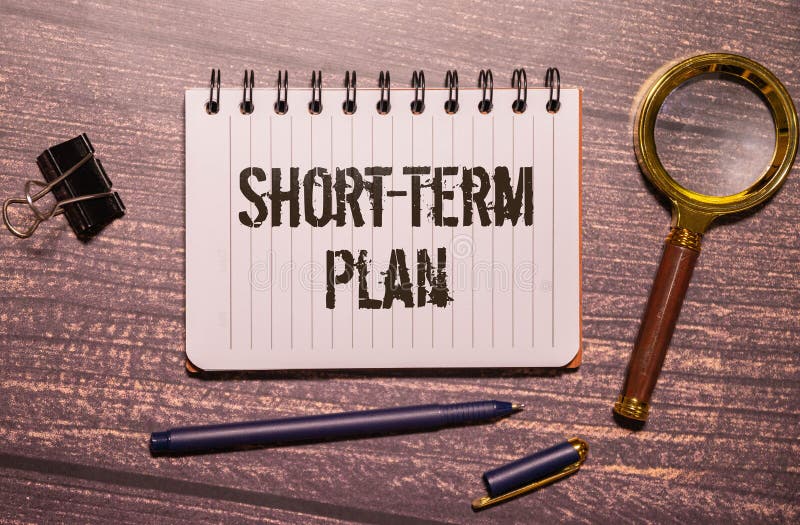 Notebook with Text SHORT-TERM PLAN on a Table with Charts,pen and ...