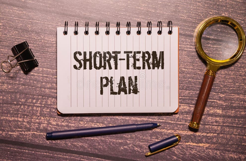 Notebook with Text SHORT-TERM PLAN on a Table with Charts,pen and ...