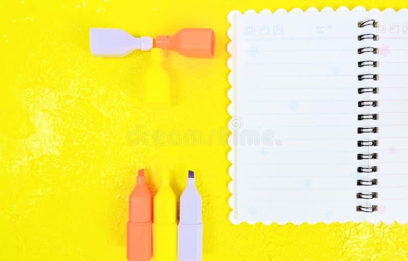 Notebook and Two Markers on a Yellow Embossed Surface Stock Photo ...