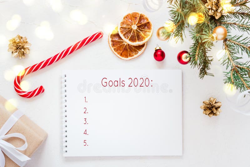 Notebook with Wish List and Christmas Decorations and Light Garland on ...