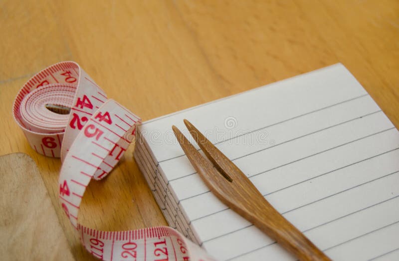Notebook with Wooden Fork and Measuring Tape on Wooden Table Stock ...