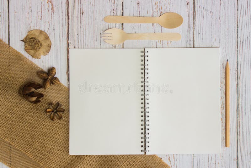 Notebook with Wooden Spoon and Fork Over the Wooden Table. Stock Image ...