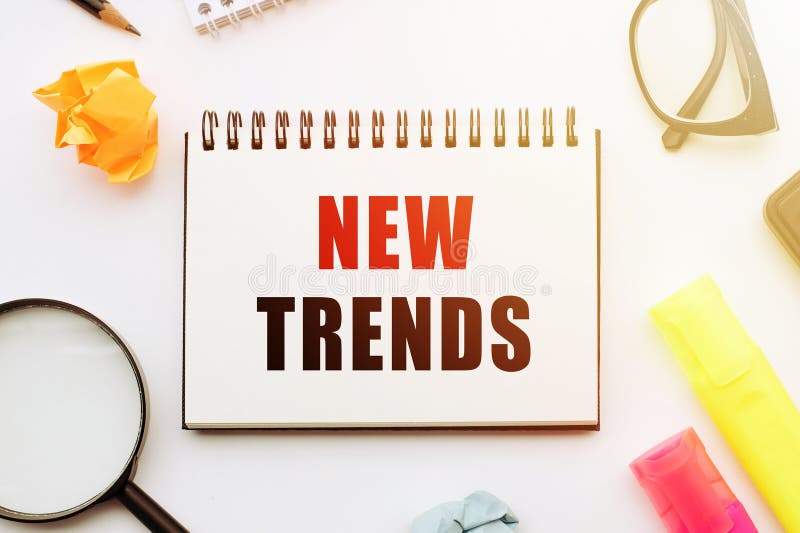 Notebook with the Words New Trends Next To a Magnifying Glass Stock ...