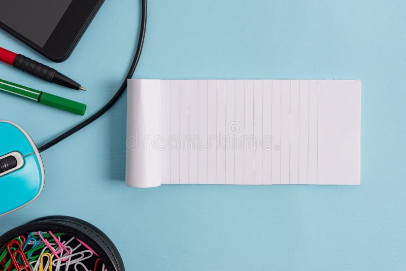 Notebook and Writing Equipment with Modern Gadget Above Pastel Backdrop ...