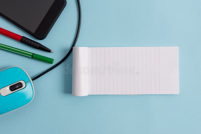 Notebook and Writing Equipment with Modern Gadget Above Pastel Backdrop ...