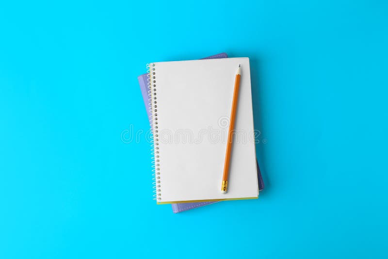 Notebooks with Pencil on Light Blue Background Stock Image - Image of ...