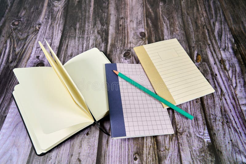 Notebooks and Stationery Placed on Wooden Table in Light Stock Image ...