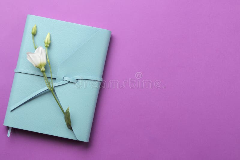 Notepad and Beautiful Eustoma Flowers on a Purple Background. Top View ...