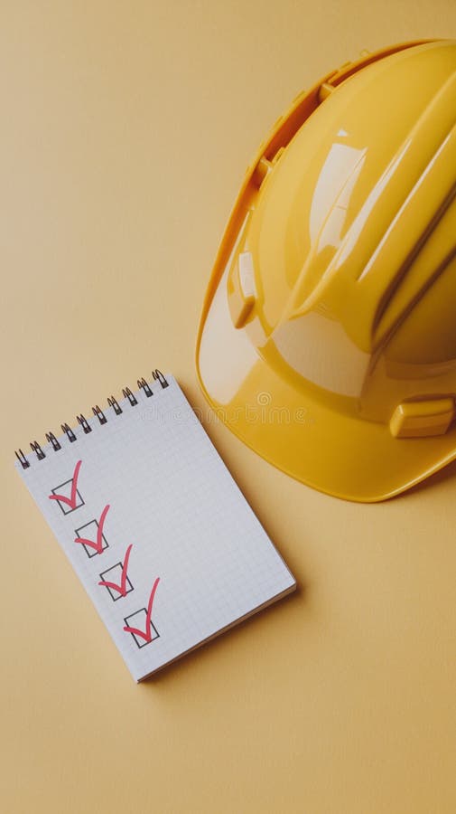 Notepad with Checkmarks beside Construction Hard Hat, Yellow Background ...
