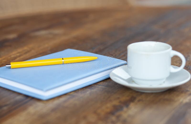 Notepad and coffee in cafe stock image. Image of white - 194883913