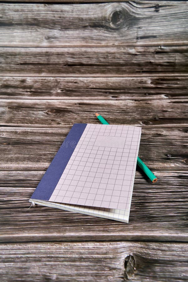 Notepad with Crossed and Parallel Lines Along with a Pencil on a Wooden ...
