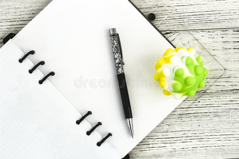 Notepad Diary with Pen and Anti-stress Ball on the Desktop Stock Photo ...