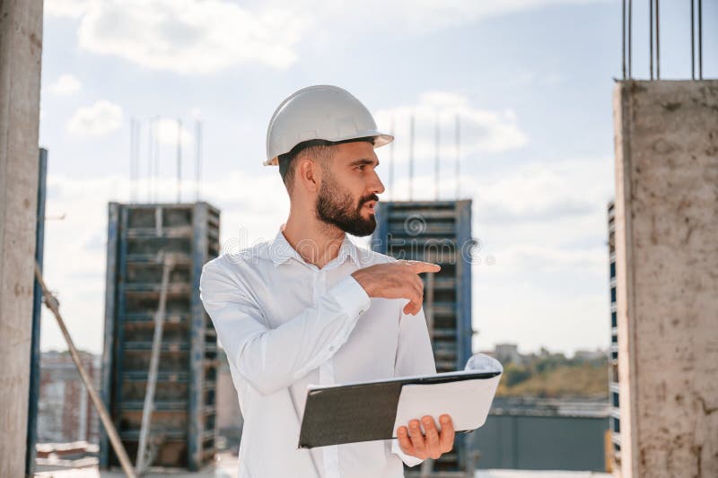With Notepad with Documents. Foreman in Uniform is Working on the ...