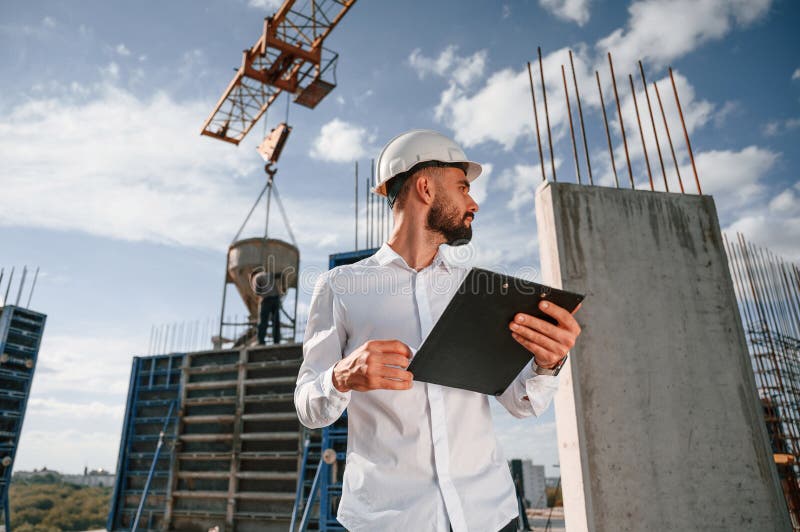 With Notepad with Documents. Foreman in Uniform is Working on the ...