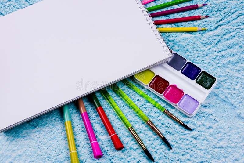 Notepad for Drawing with Paints and Multi-colored Pancils on a Blue ...