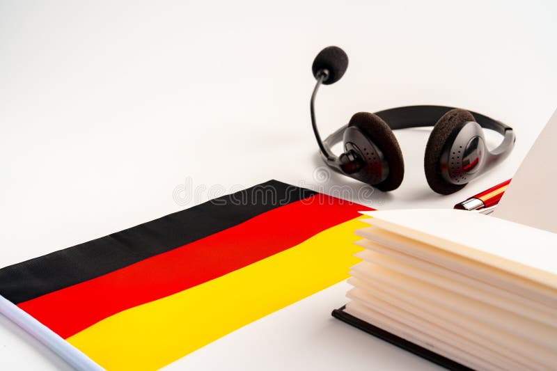 Notepad with German Flag and Headphones on White Background. German ...