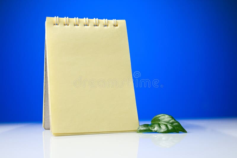 Notepad with green leaves stock image. Image of message - 22451411