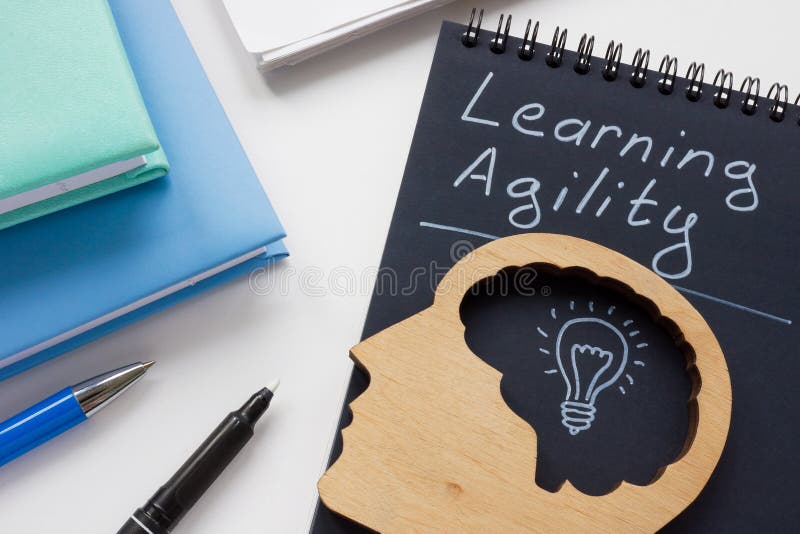 Notepad with Inscription Learning Agility and Head Model. Stock Photo ...