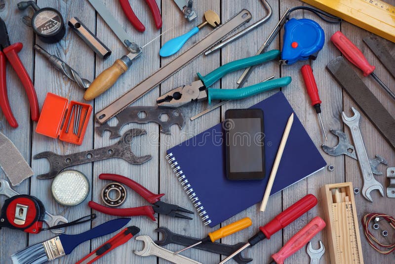 Notepad, Mobile Phone and Tools on a Wooden Floor, Top View. Stock ...