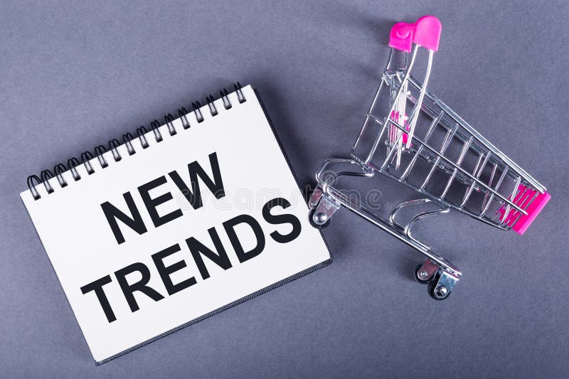 A Notepad with NEW TRENDS Written beside a Tiny Shopping Cart ...