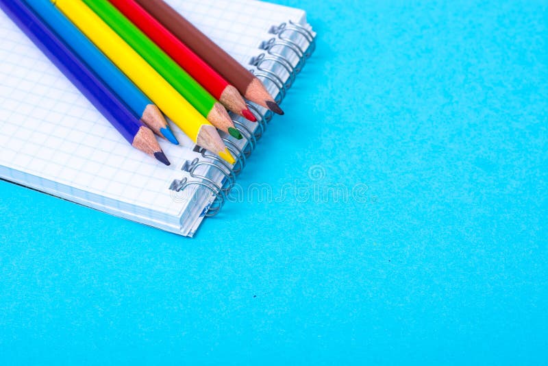 Notepad for Notes and Colorful Pencils on Colored Background Stock ...