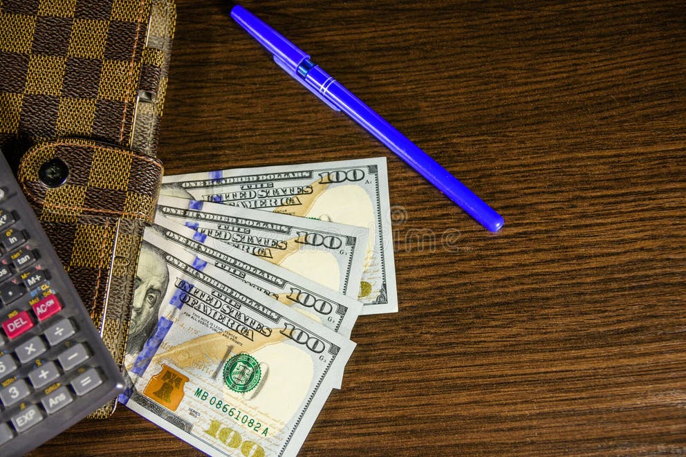 Notepad, Pen, Calculator and Dollar Bills on Wooden Table. Top View ...