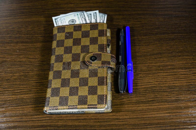 Notepad, Pen, and Dollar Bills on Wooden Table Stock Photo - Image of ...