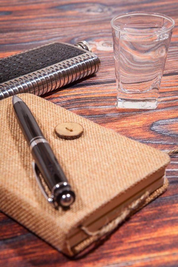 Notepad, Pen, Glass and Flask on the Wooden Table Stock Image - Image ...