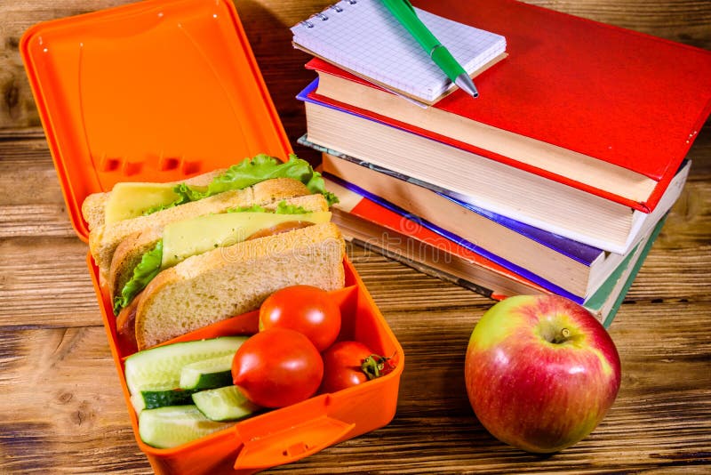 Notepad, Pen, Ripe Apple, Stack of Books and Lunch Box with Sandwiches ...