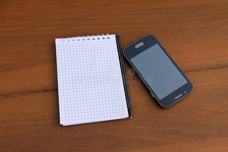 Notepad with Pen and Smartphone on Wooden Desk Stock Image - Image of ...