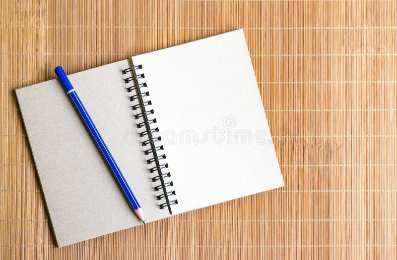Notepad with Pencil on Wood Board Background.using Wallpaper for ...