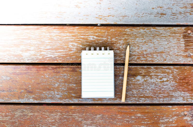 Notepad with Pencil on Wood Board Background. Using Wallpaper or ...