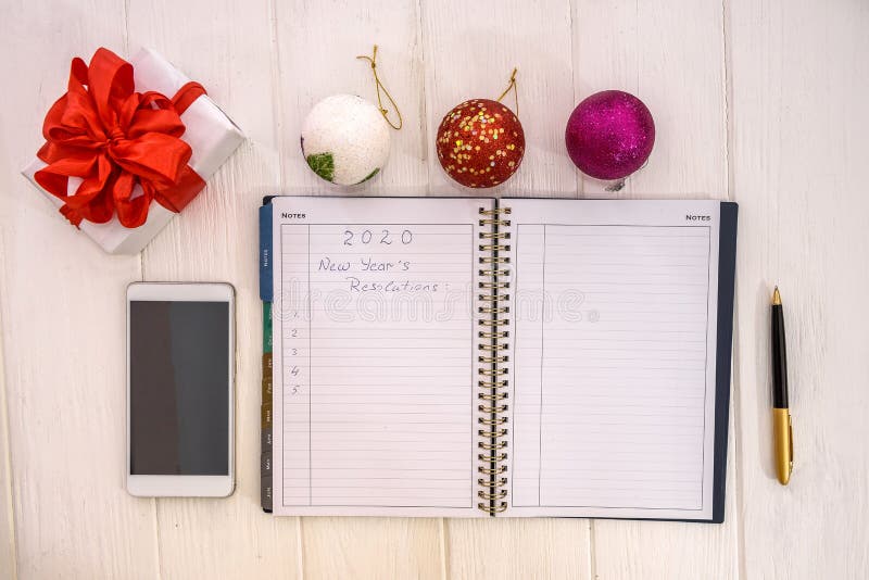 Notepad and Phone on Table with New Year Resolution Stock Image - Image ...