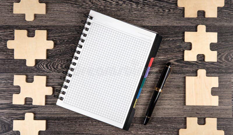 Notepad with Puzzle Pieces with a Pen Stock Photo - Image of figure ...