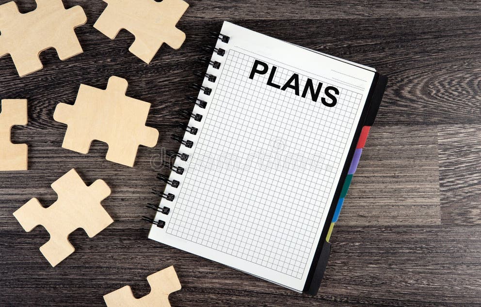 Notepad with Puzzle Pieces on a Wooden Background Stock Image - Image ...