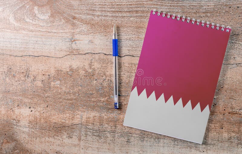 Notepad with Qatar Flag, Pen on Wooden Background Stock Image - Image ...