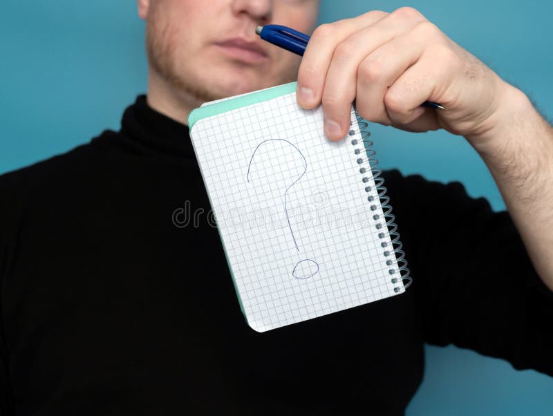 Notepad with a Question Mark in the Hand of a Young Man Studio Shot on ...